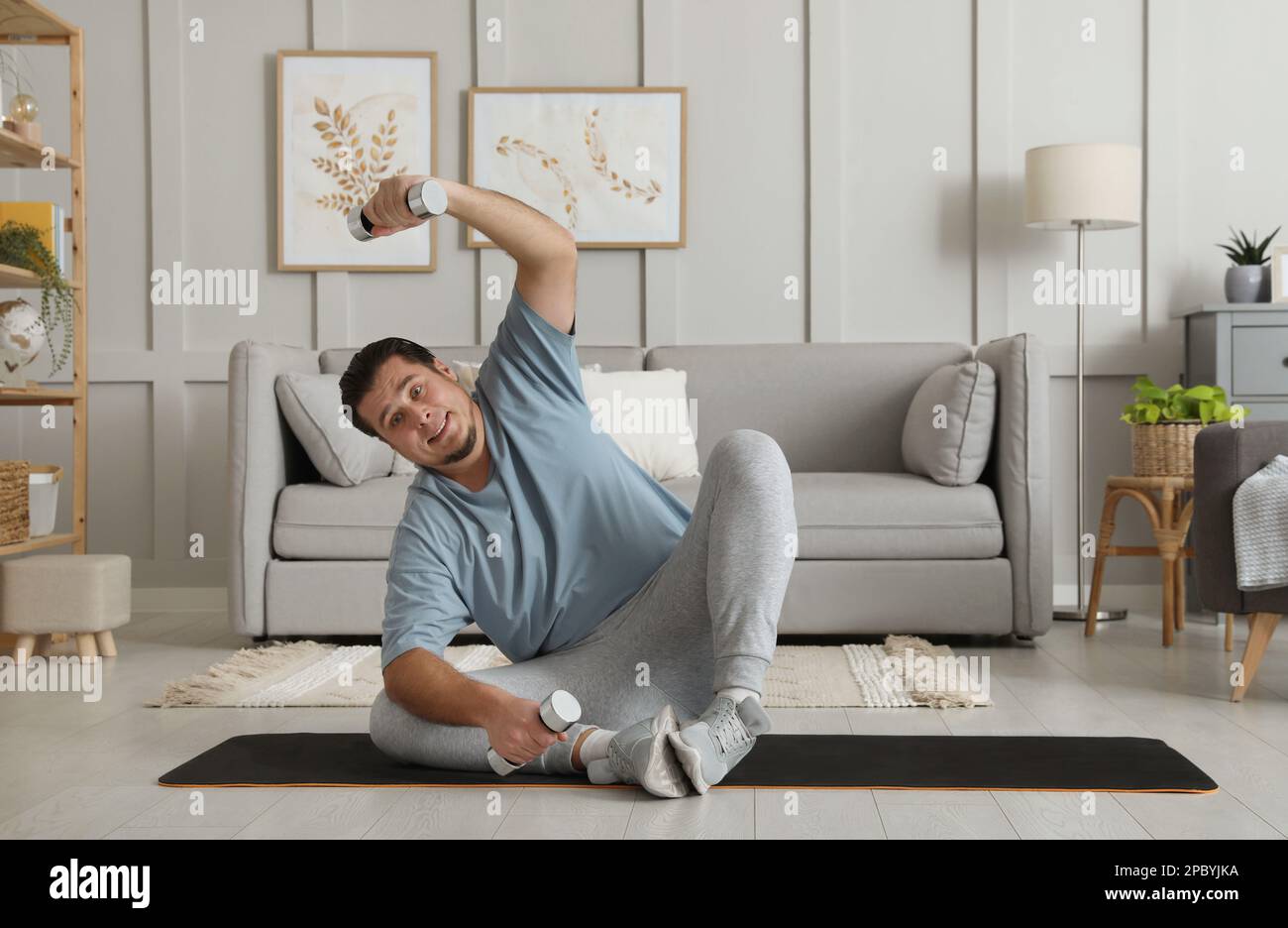 Obese man doing yoga on mat hi-res stock photography and images - Alamy