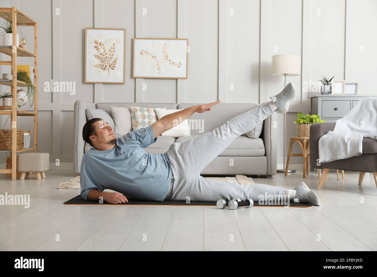 Obese man doing yoga on mat hi-res stock photography and images - Alamy