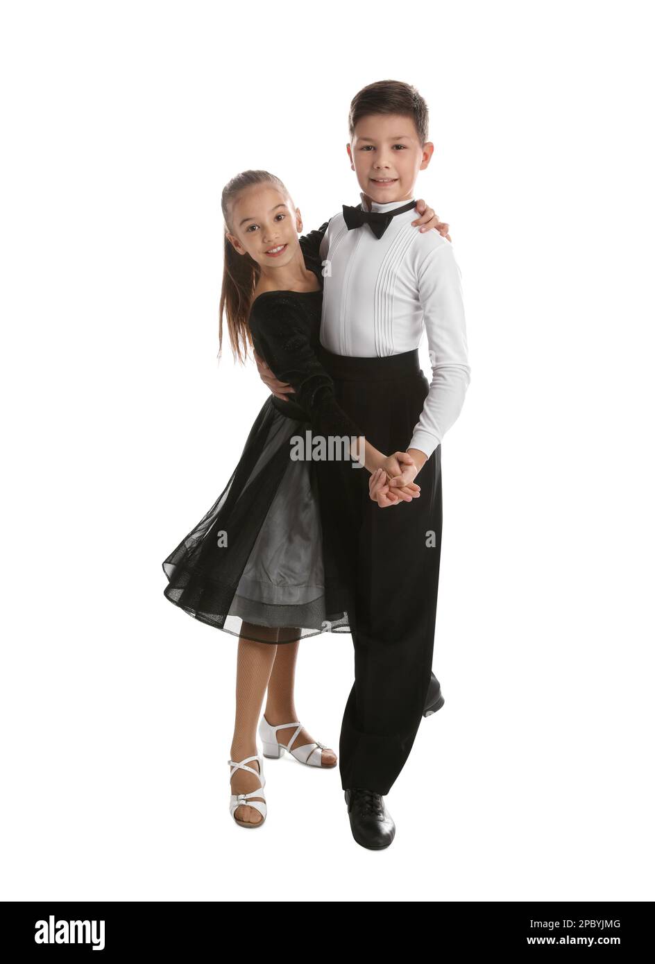 Beautifully dressed couple of kids dancing on white background Stock ...
