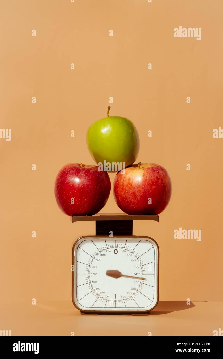 Fresh and juicy red and green apples on weighing scale as part of ...