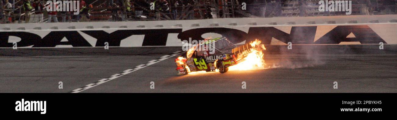 The burning truck of NASCAR Craftsman Series driver Terry Cook slides ...