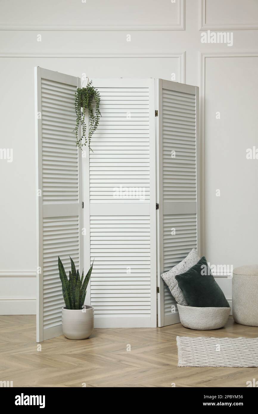 Stylish room with folding screen and floral decor. Interior design ...