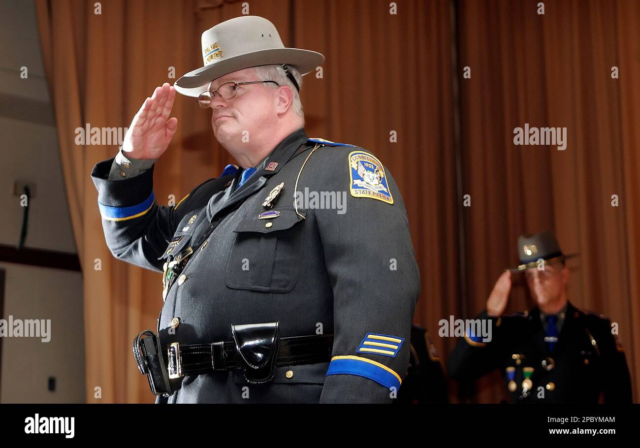 Connecticut State Police Col. Thomas Davoren, left, salutes the ...