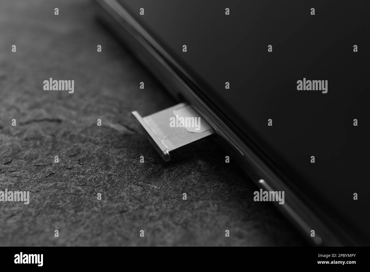 Mobile phone with Sim card in tray on grey table, closeup Stock Photo ...