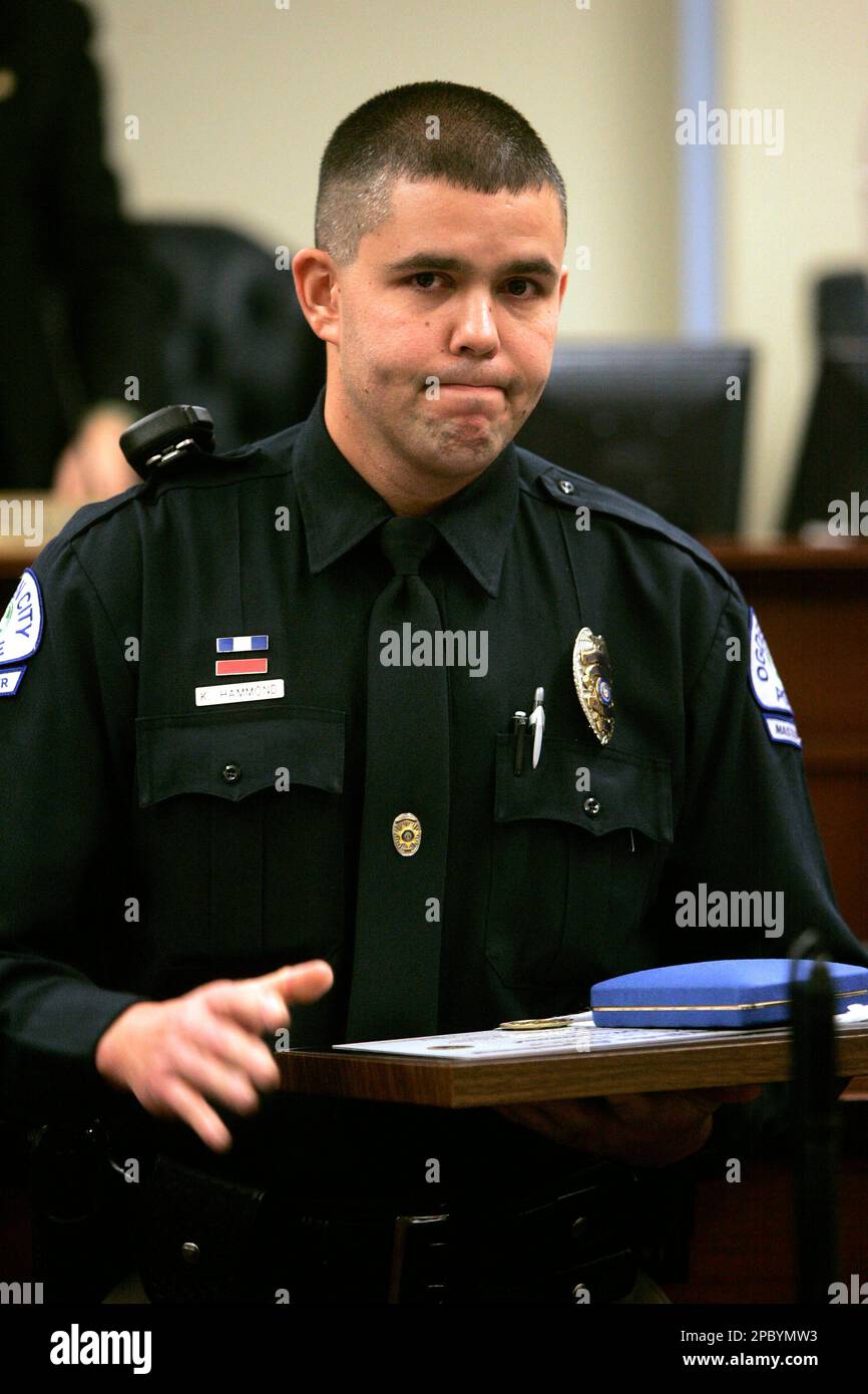 Ogden City Master Officer Ken Hammond reacts to being given a medal of ...