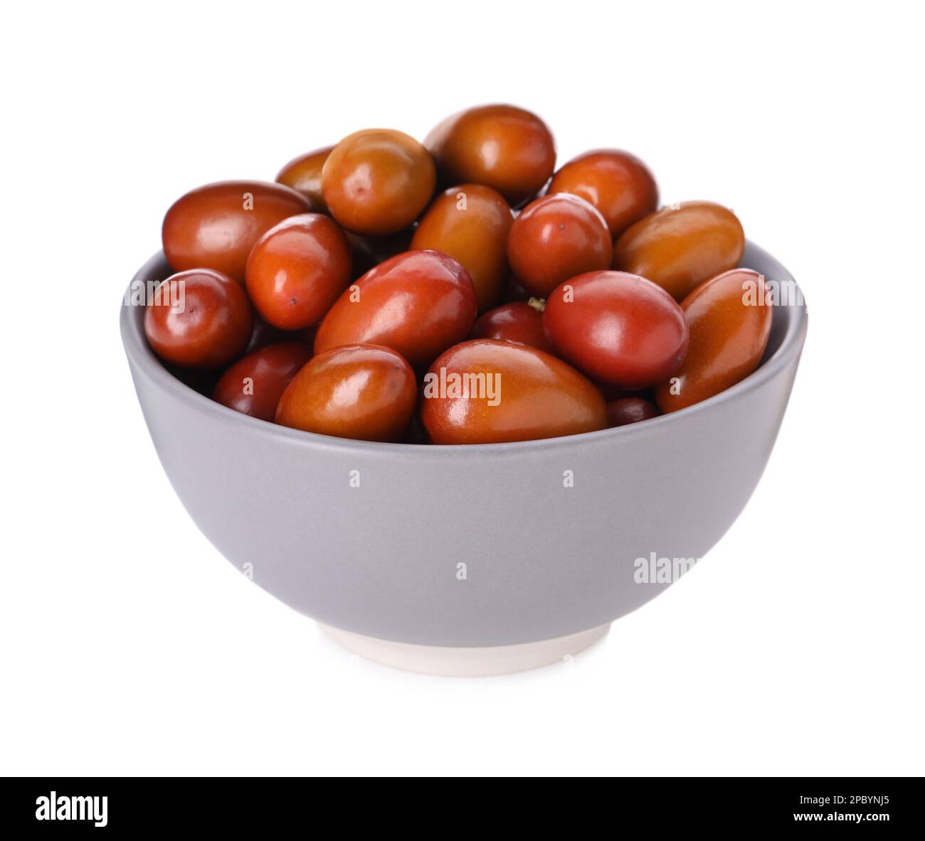 Ripe red dates in bowl on white background Stock Photo - Alamy