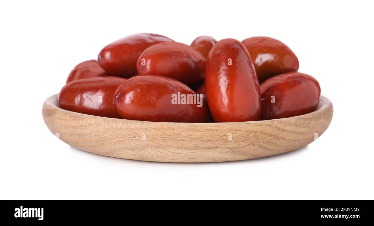 Wooden plate of ripe red dates on white background Stock Photo - Alamy