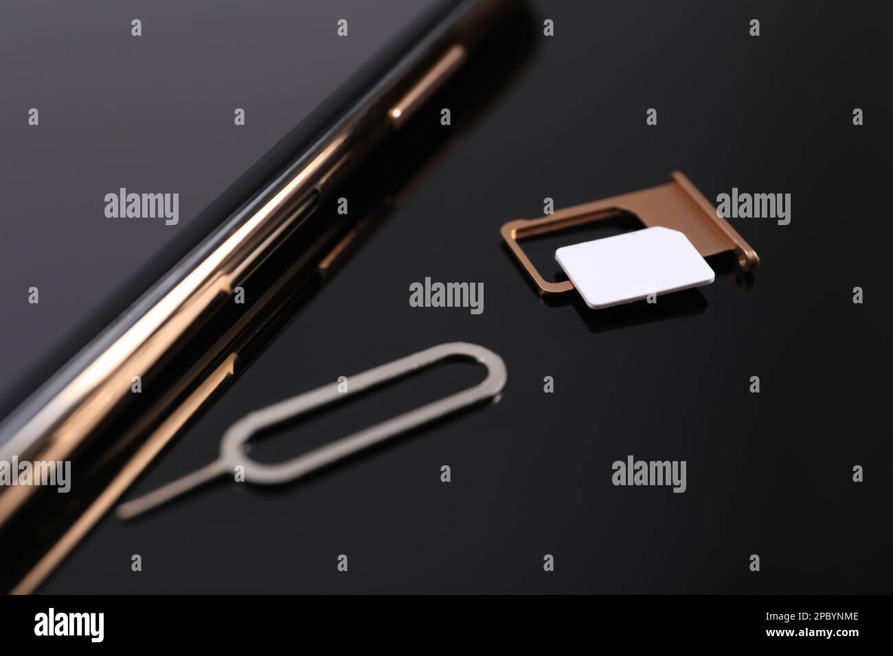 SIM card, smartphone and ejector on black background, closeup Stock ...