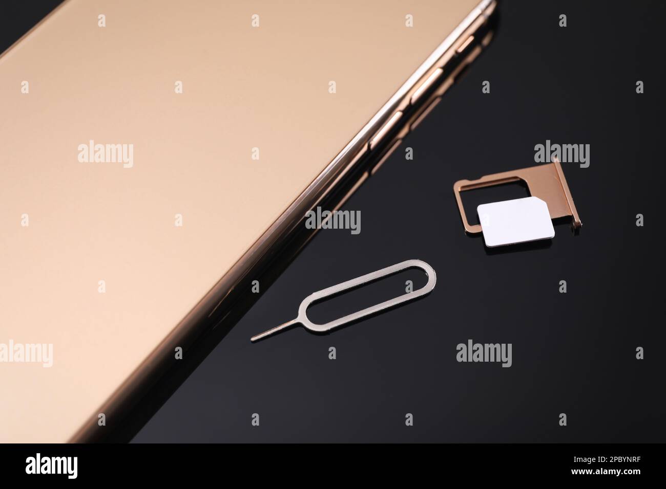 SIM card, smartphone and ejector on black background, above view Stock ...