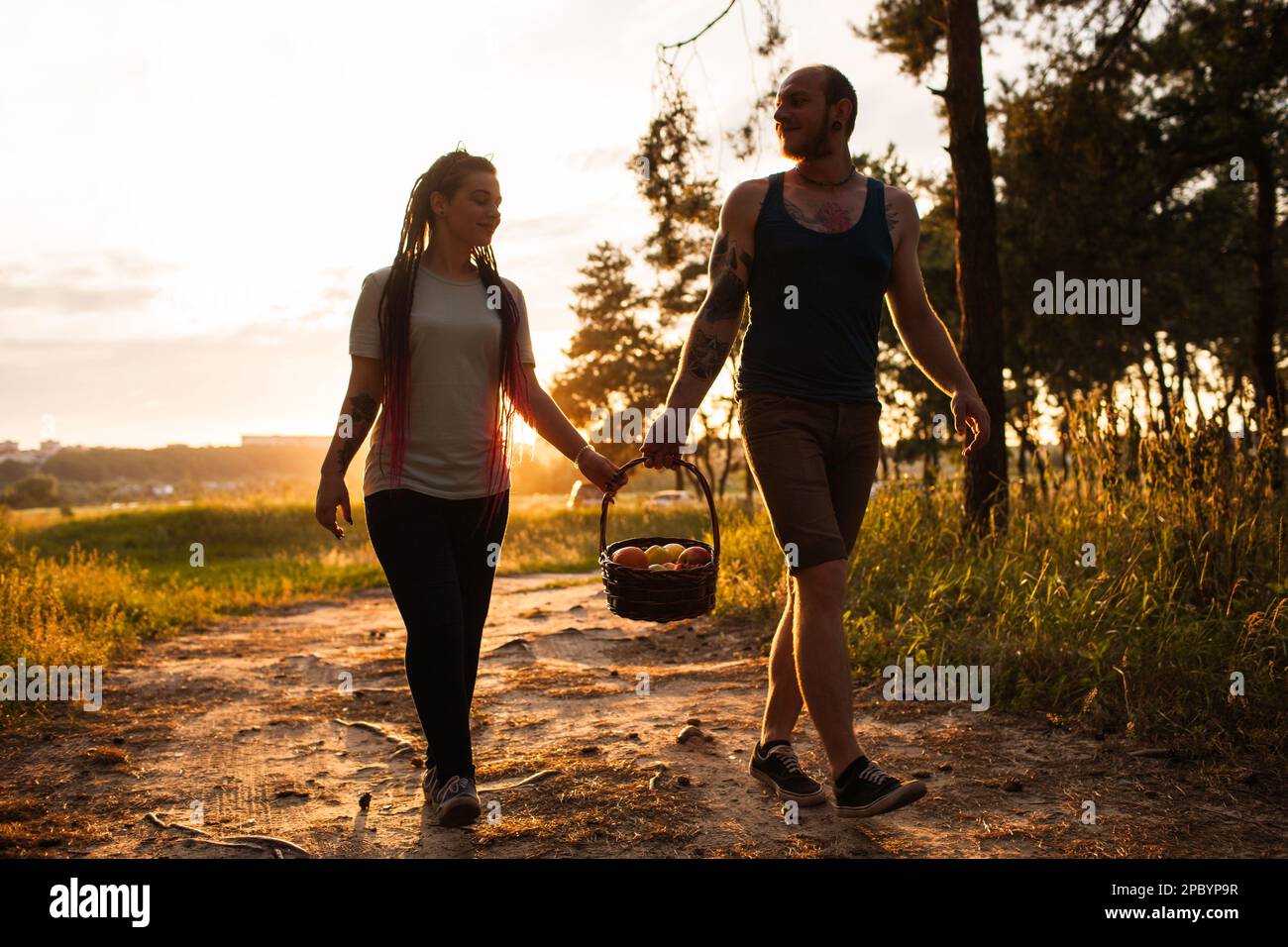 Couple walk informal meadow picnic love concept Stock Photo - Alamy