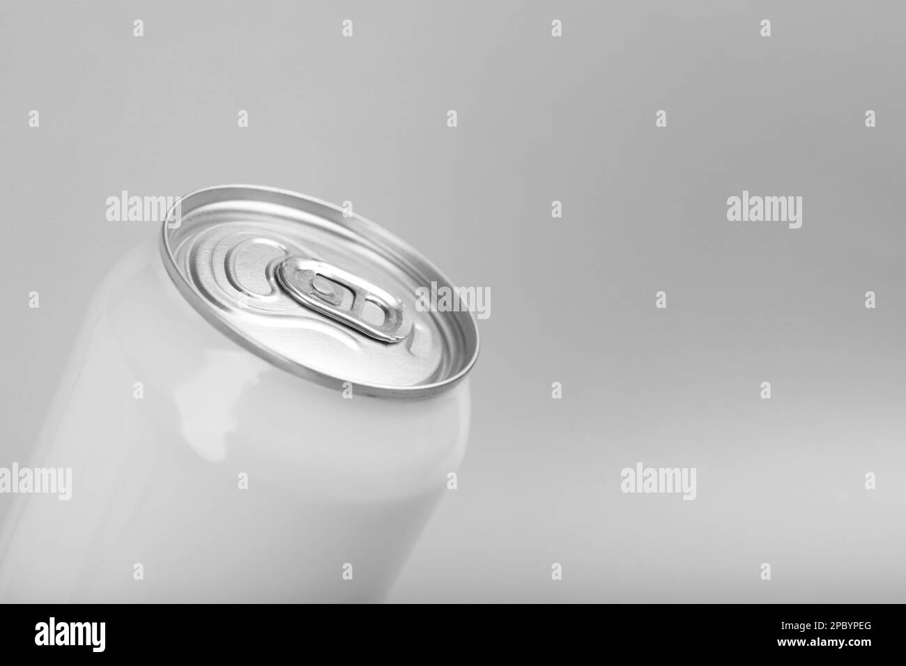 White can of energy drink on light grey background, closeup. Space for ...