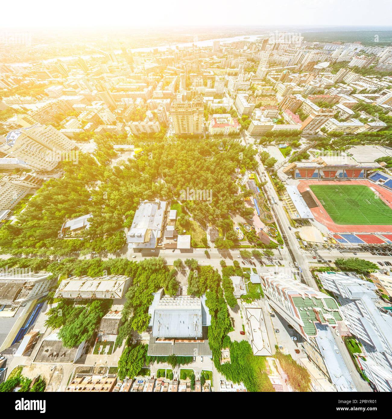 Aerial city view with crossroads and roads, houses, buildings, parks ...
