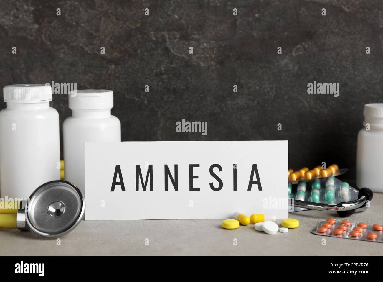 Card with word Amnesia, drugs and stethoscope on light grey table Stock ...
