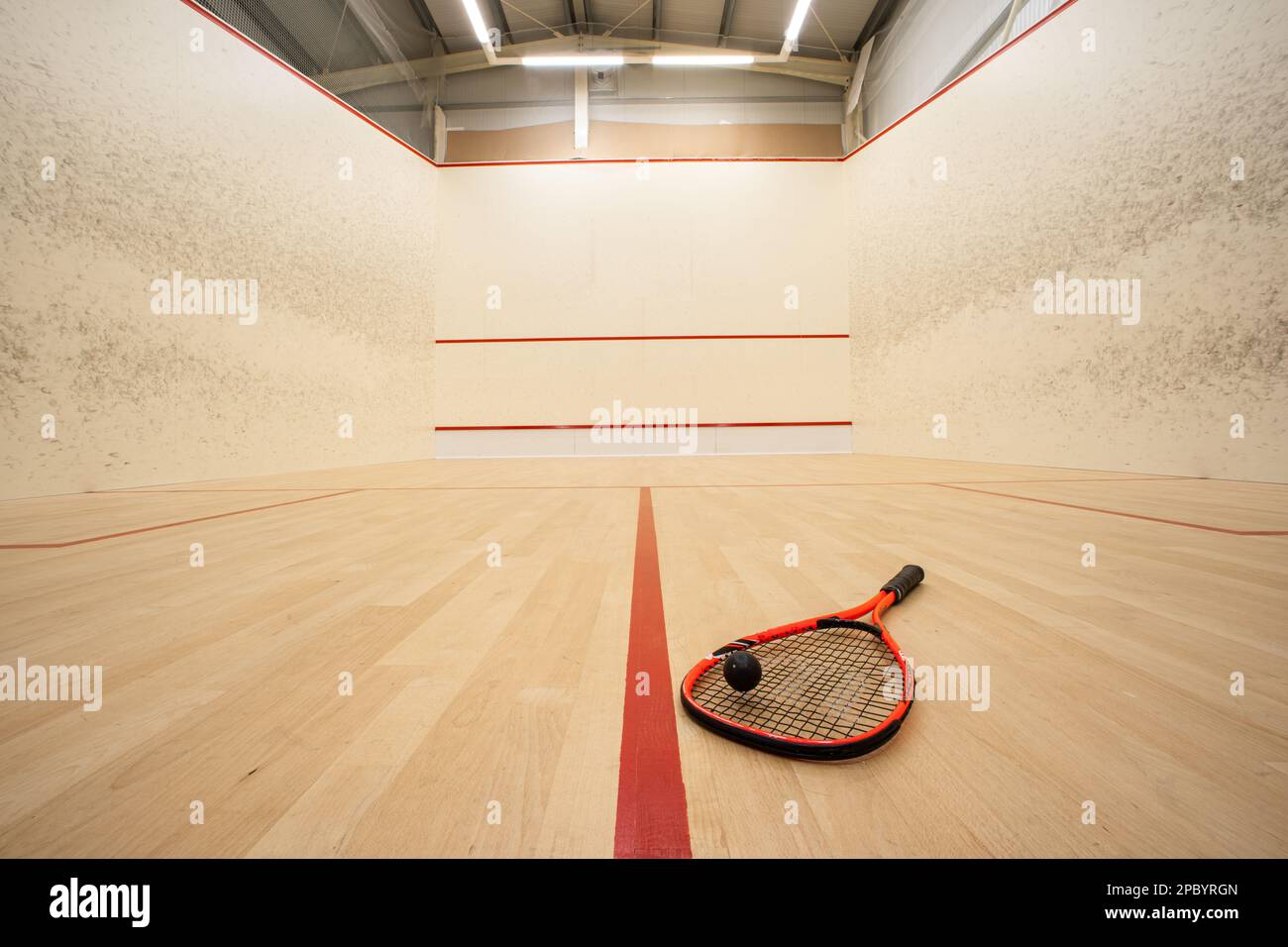 Empty squash court ultra-wide angle view. Racket and ball on the ground ...