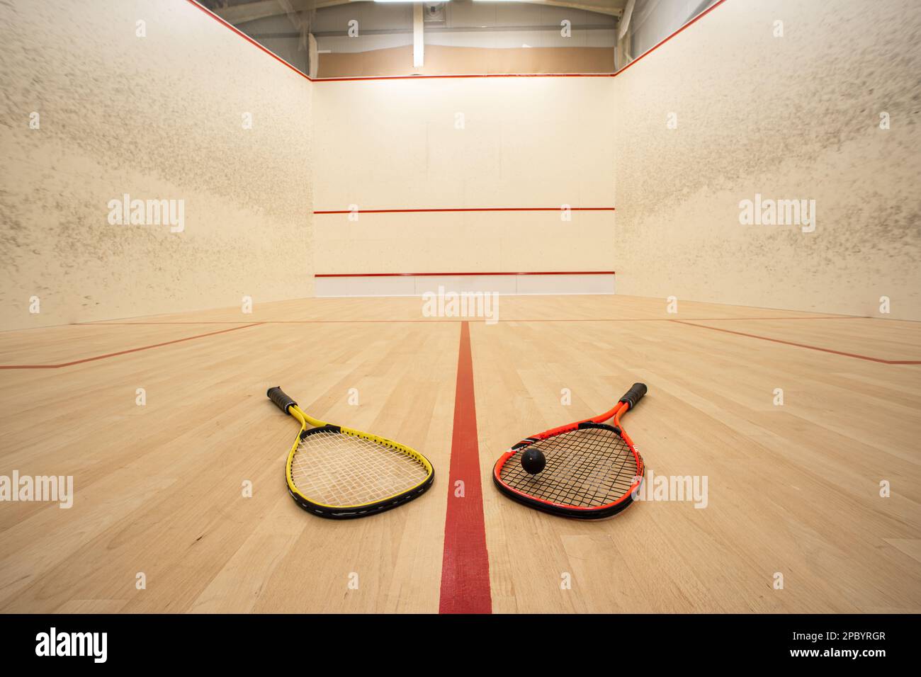 Empty squash court ultra-wide angle view. Racket and ball on the ground ...