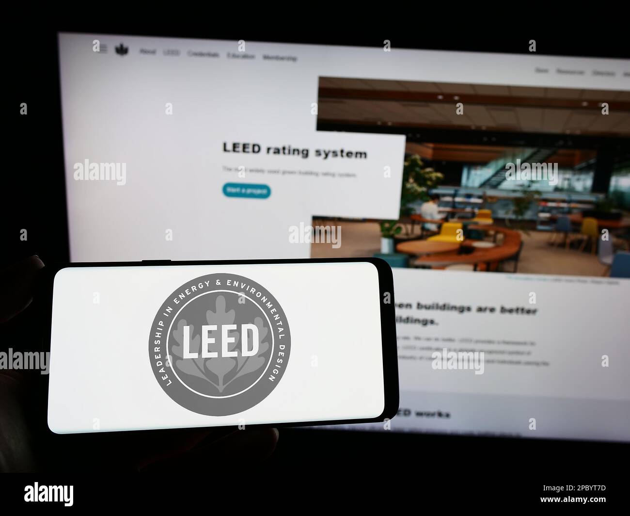Person holding smartphone with logo of US green building certification ...