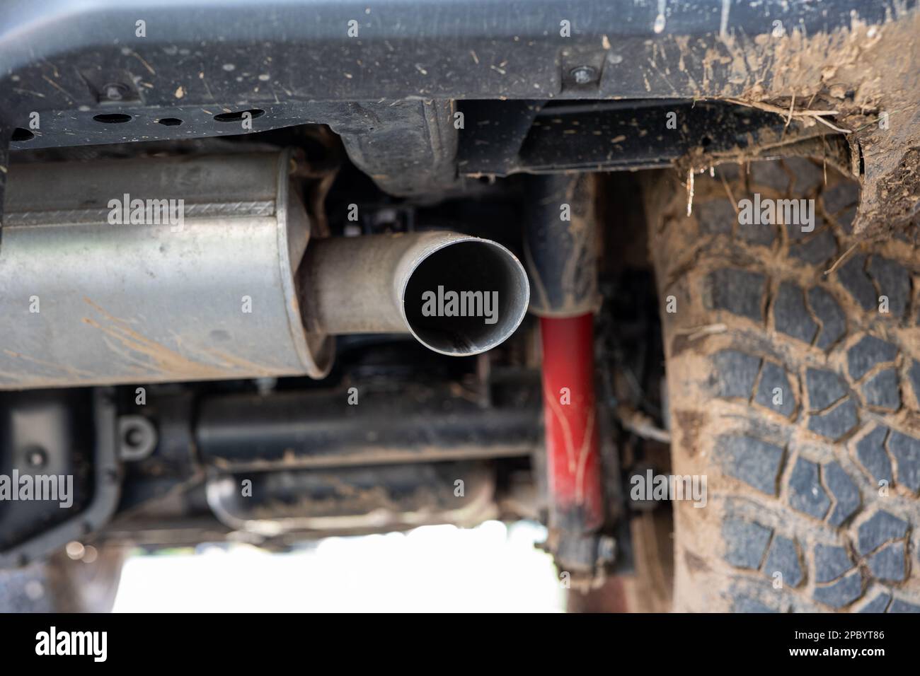 SUV car exhaust muffler or resonator and tip. Low angle view, no people ...