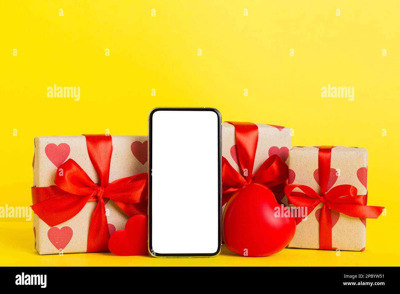 mobile phone with blank screen on colored background with hearts ...