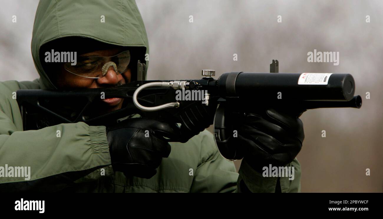 Navy civilian Steven Nettles takes aim with an air rifle shooting ...