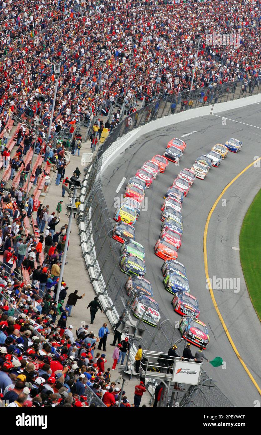 Cars race past the start-finish line at the start of the Gatorade Duel ...
