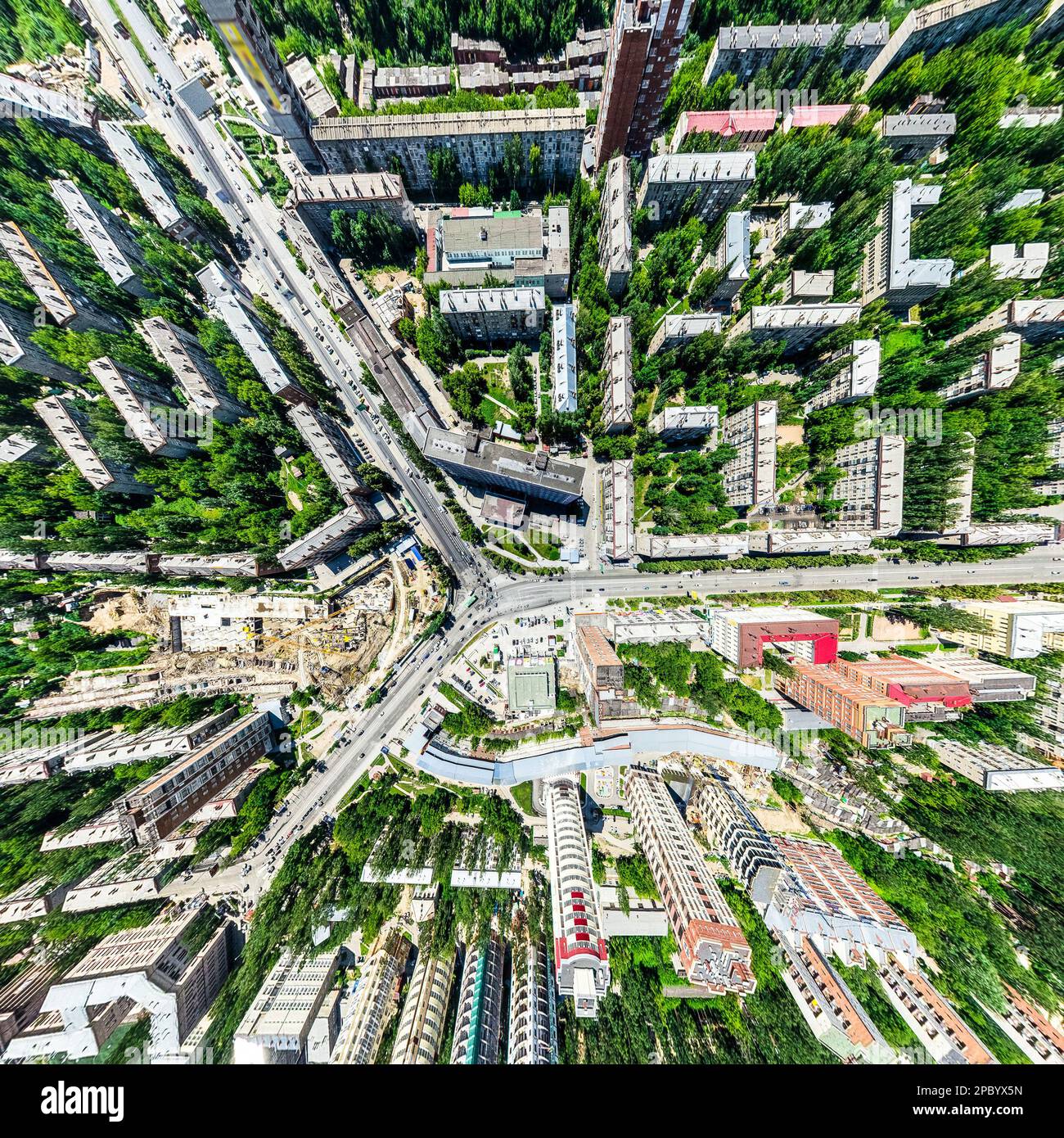 Aerial city view with crossroads and roads, houses, buildings, parks ...