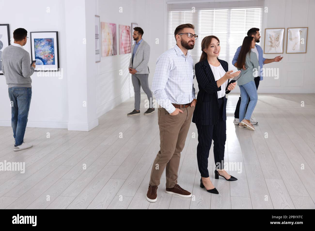 People viewing exposition in modern art gallery Stock Photo - Alamy