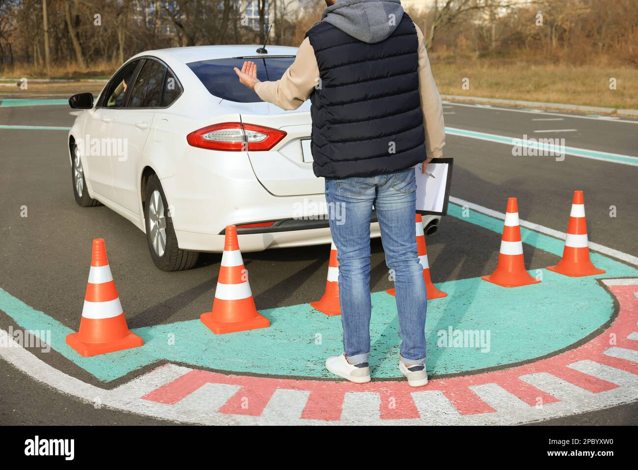 Instructor and student in car during exam on test track. Driving school ...