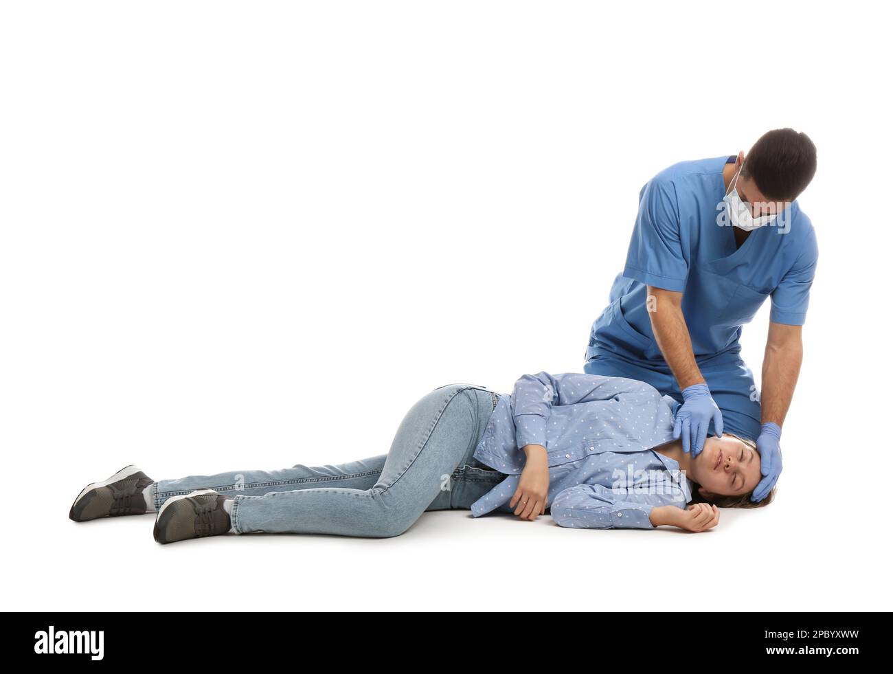 Doctor in uniform practicing first aid on woman against white ...