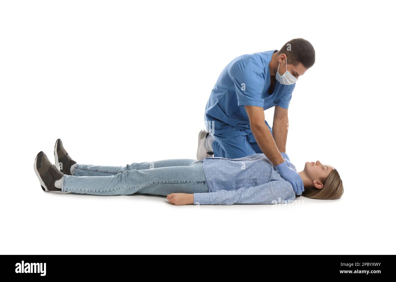 Doctor in uniform practicing first aid on woman against white ...