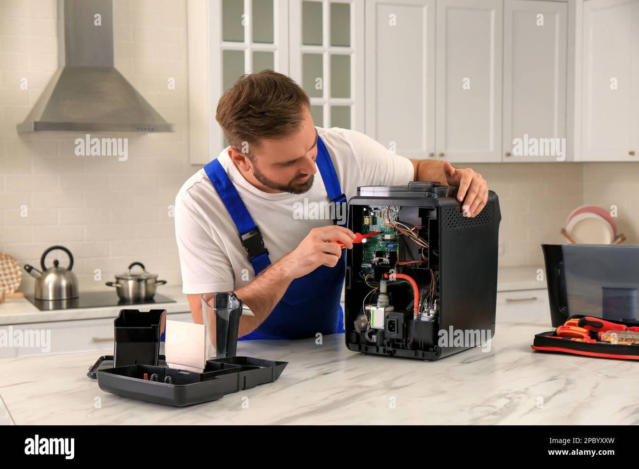 Repairman screwdriver fixing coffee hi-res stock photography and images ...