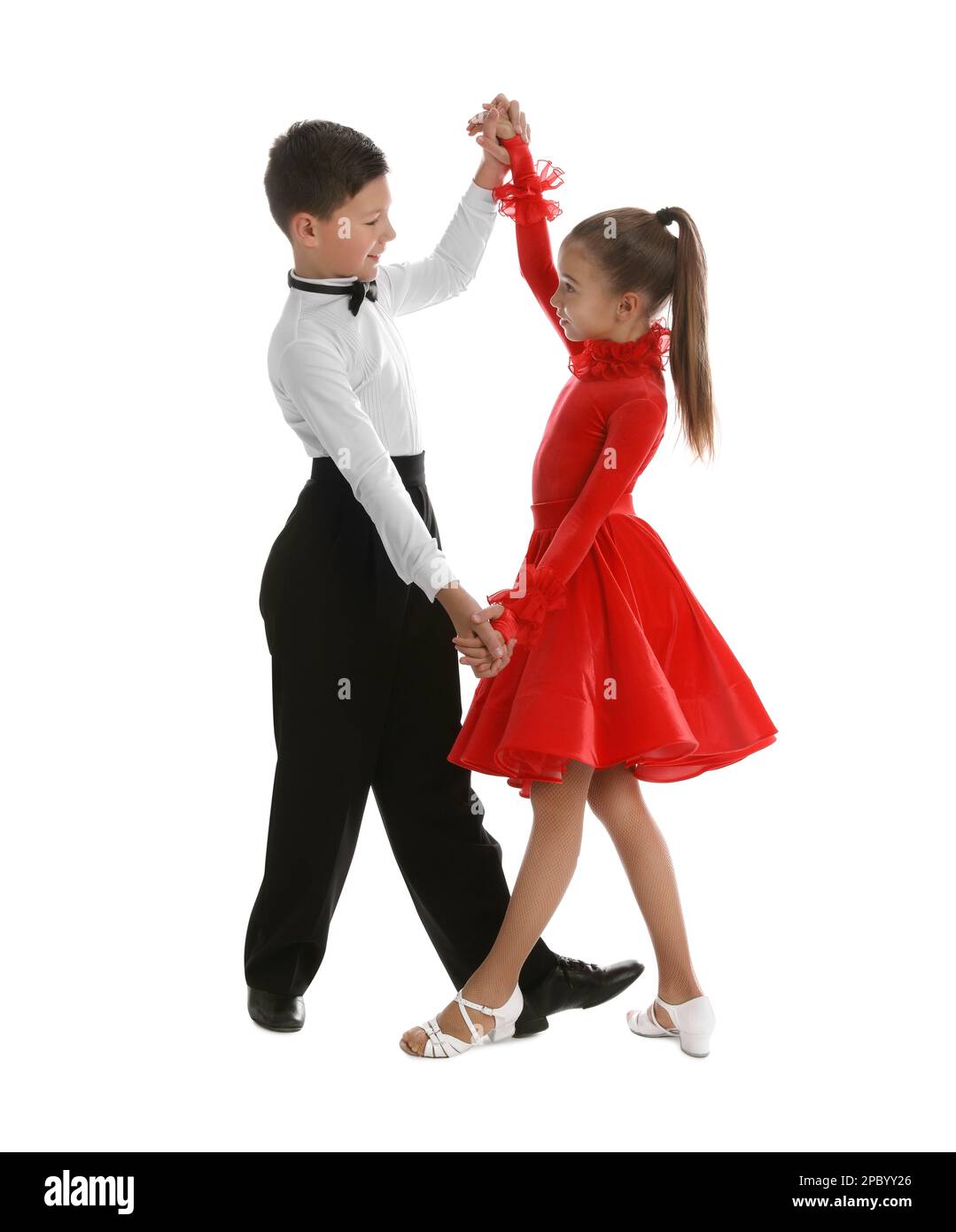Beautifully dressed couple of kids dancing on white background Stock ...