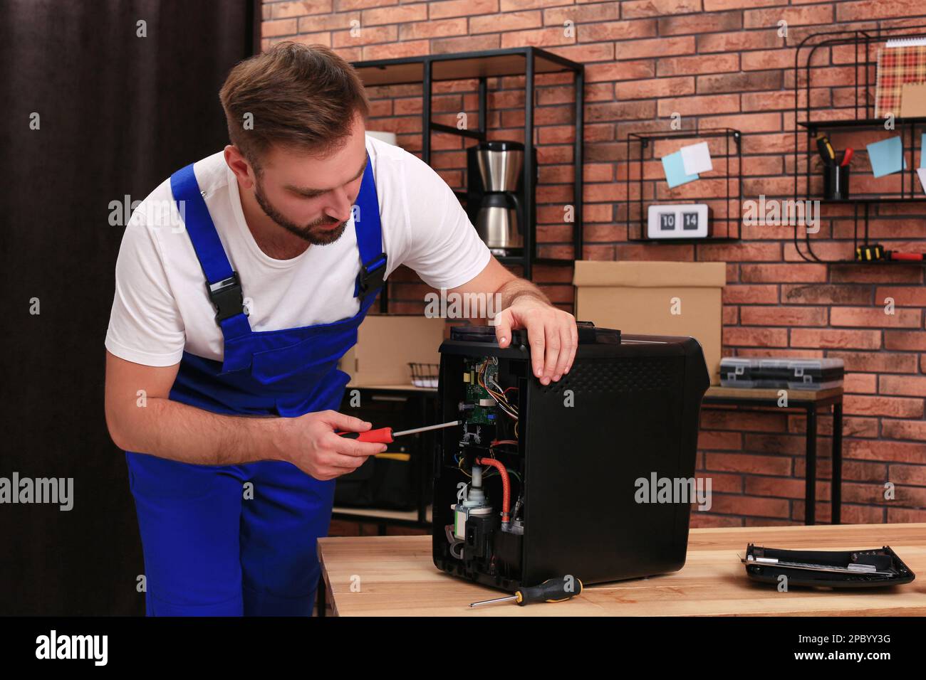 Repairman screwdriver fixing coffee hi-res stock photography and images ...