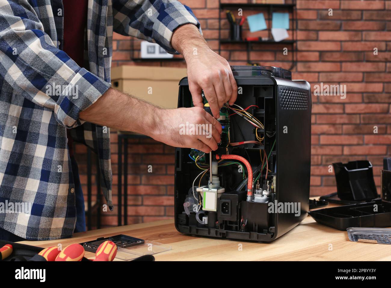 Man fixing coffee machine hi-res stock photography and images - Alamy