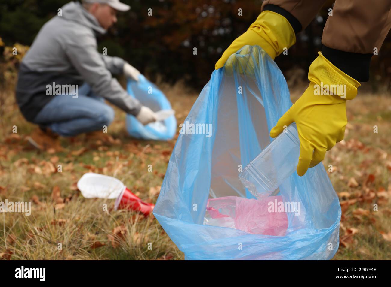 People with trash bags collecting garbage in nature, closeup Stock ...