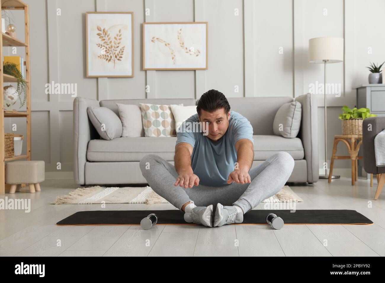 Obese man doing yoga on mat hi-res stock photography and images - Alamy