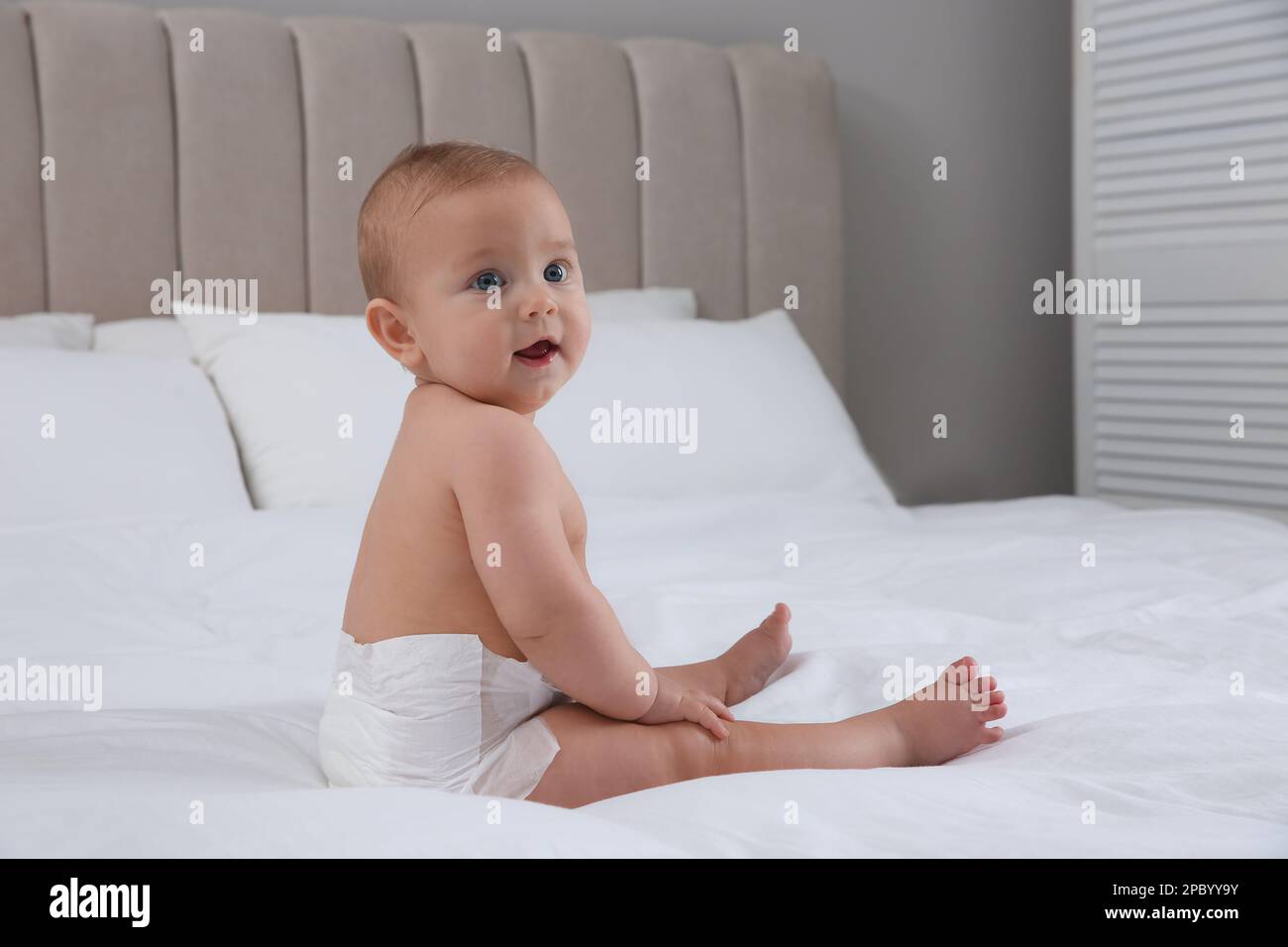 Cute baby in dry soft diaper on white bed at home Stock Photo - Alamy