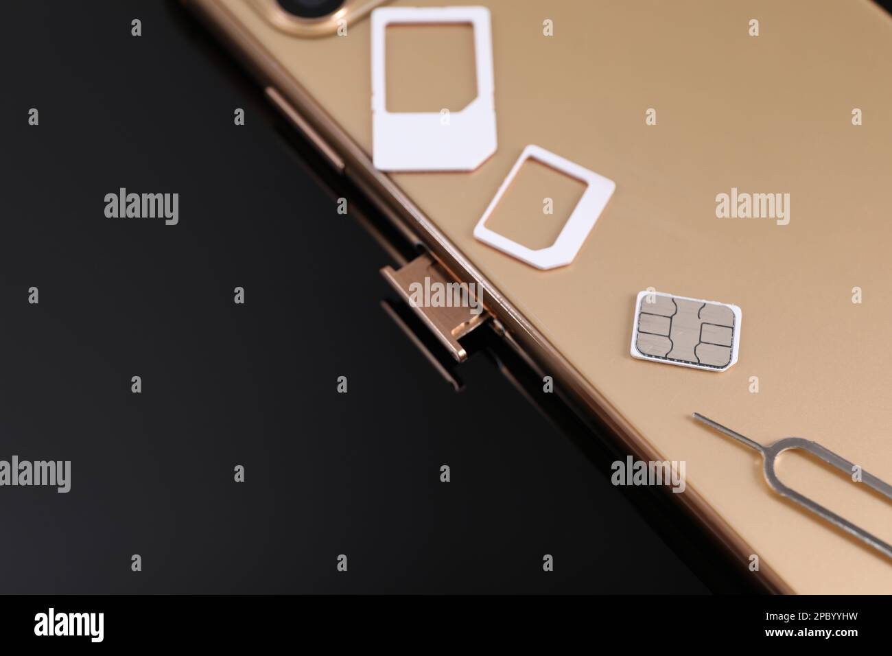 SIM card, smartphone and ejector on black background, closeup Stock ...