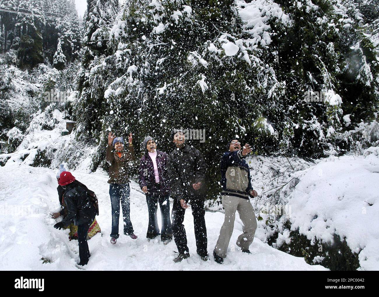 Tourists play in the snow in Darjeeling, India, Thursday, Feb. 15, 2007 ...