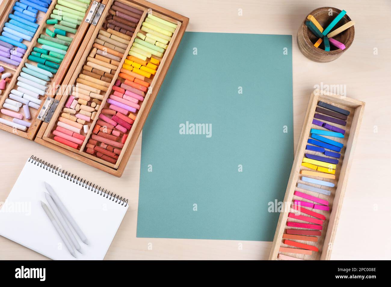 Layout with blank paper, soft pastels and other drawing supplies on ...