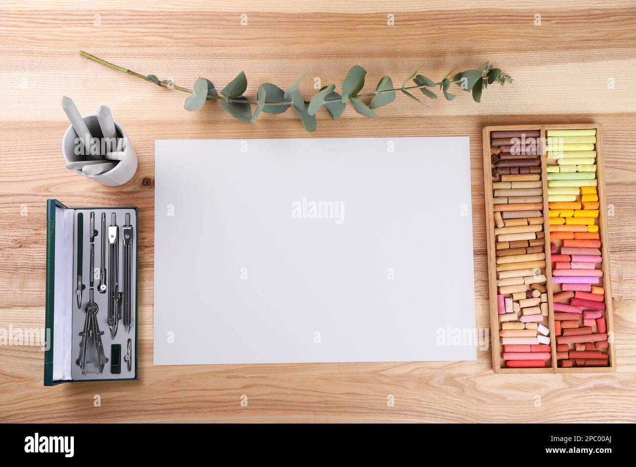 Layout with blank paper, soft pastels and other drawing supplies on ...