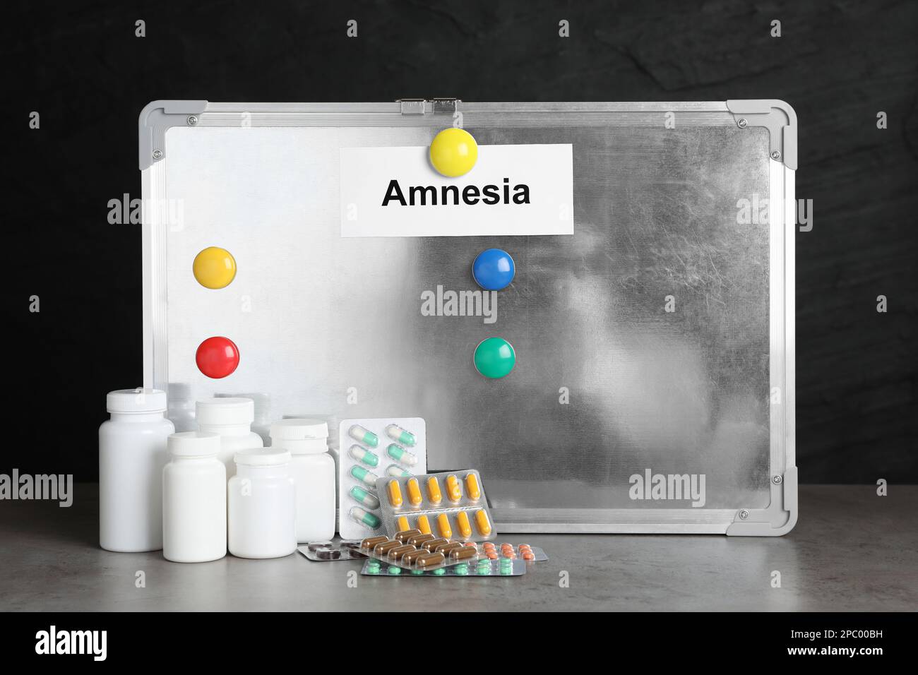 Magnetic board with word Amnesia and drugs on light grey table Stock ...
