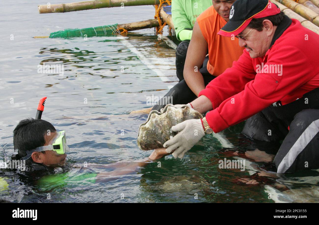 Mayor Edward Hagedorn, right, hands a giant clam, locally known as ...