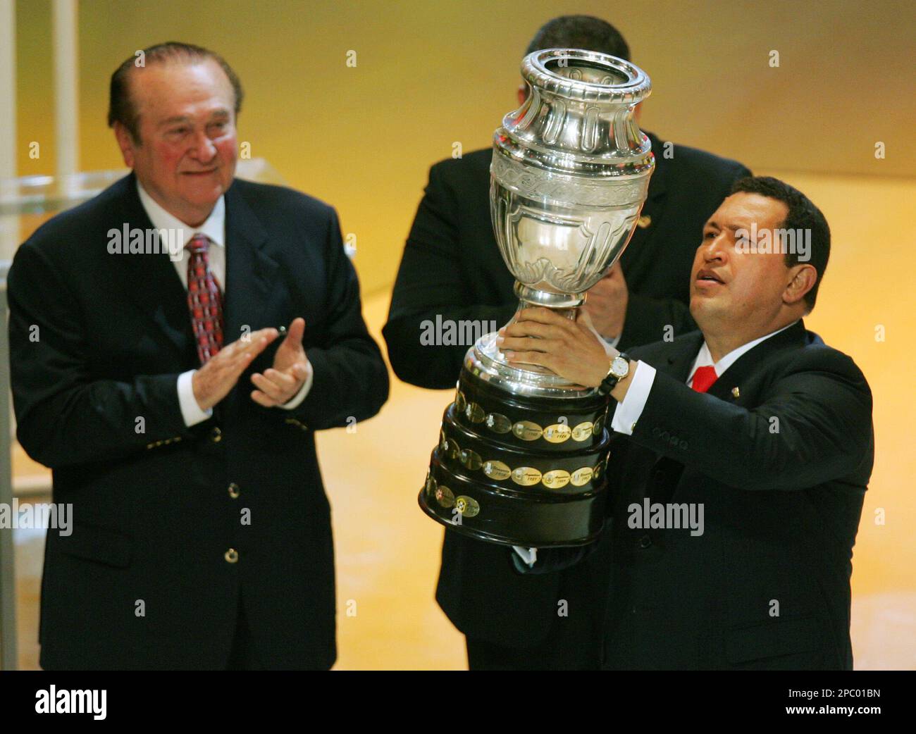 Venezuela's President Hugo Chavez holds the Copa America trophy as ...