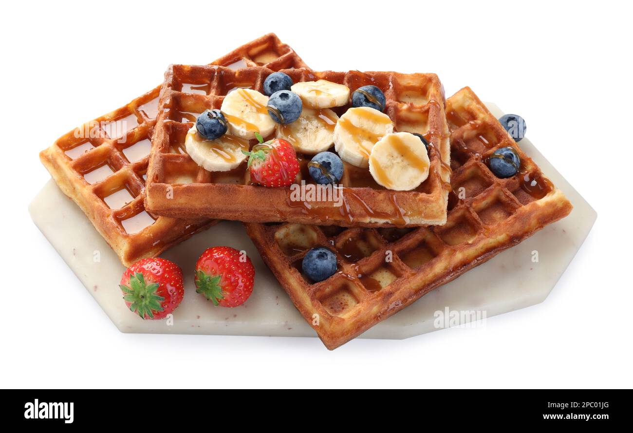 Board with delicious Belgian waffles, banana, berries and caramel sauce ...