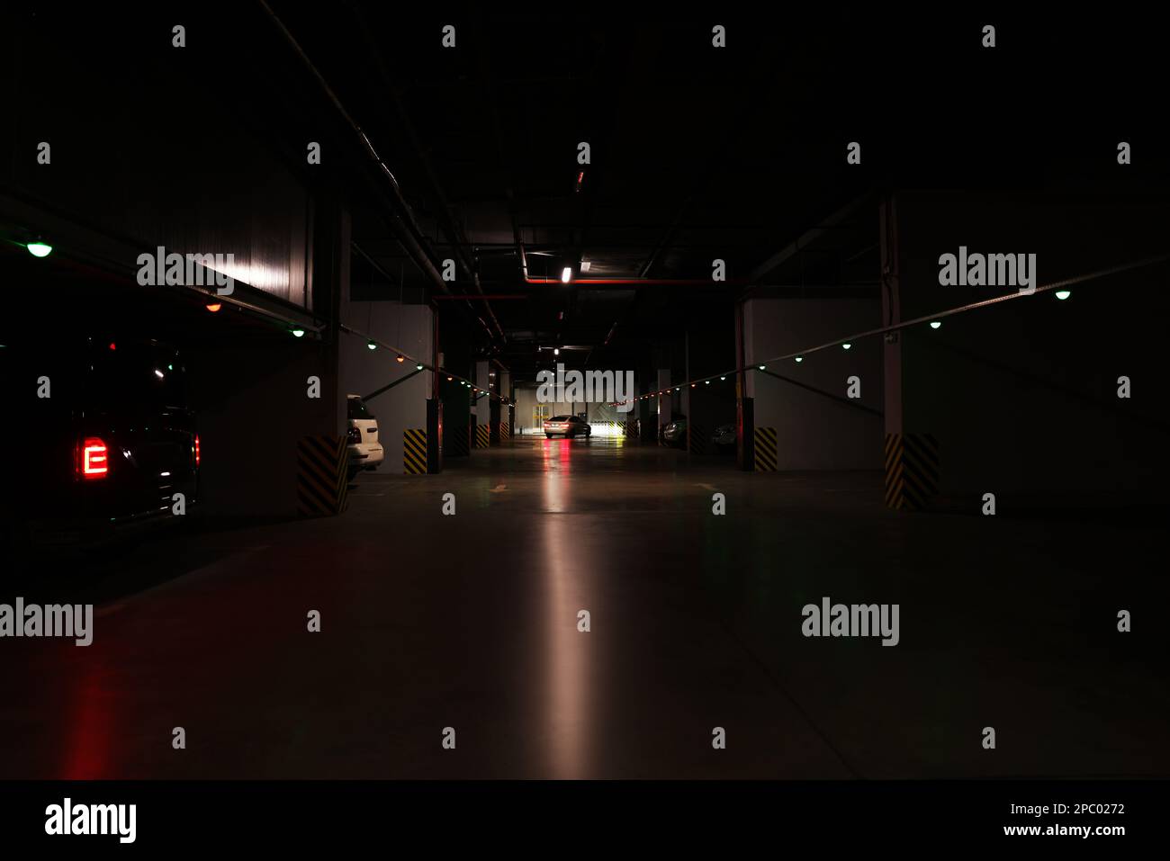 Modern parking garage with cars at night Stock Photo - Alamy