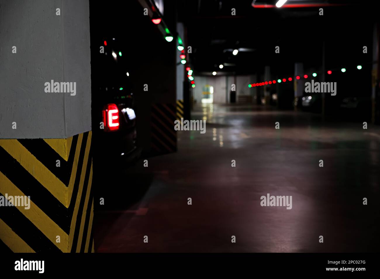 Modern parking garage with cars at night Stock Photo - Alamy