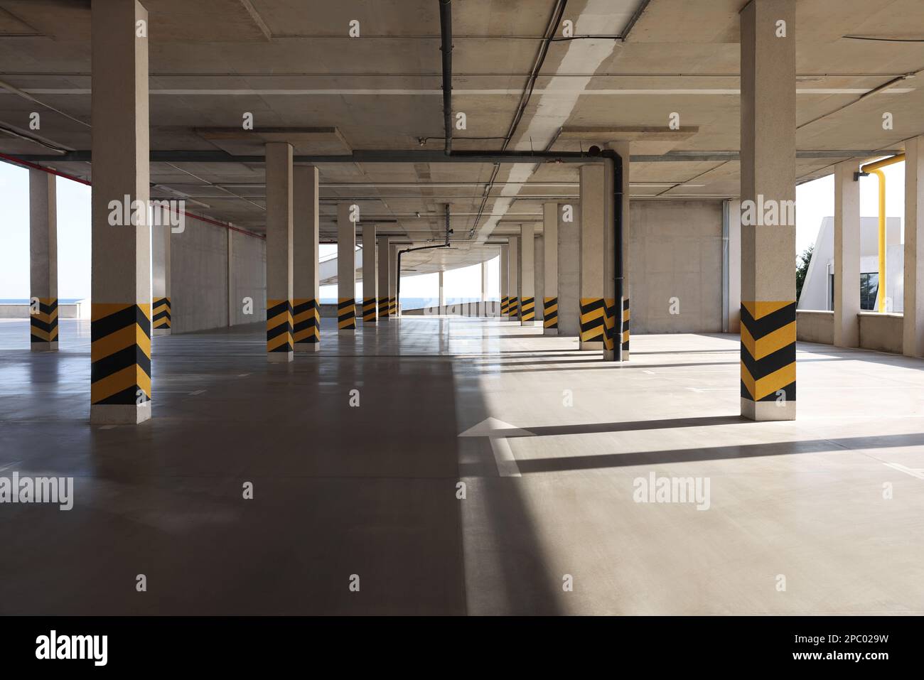 Empty open car parking garage on sunny day Stock Photo - Alamy