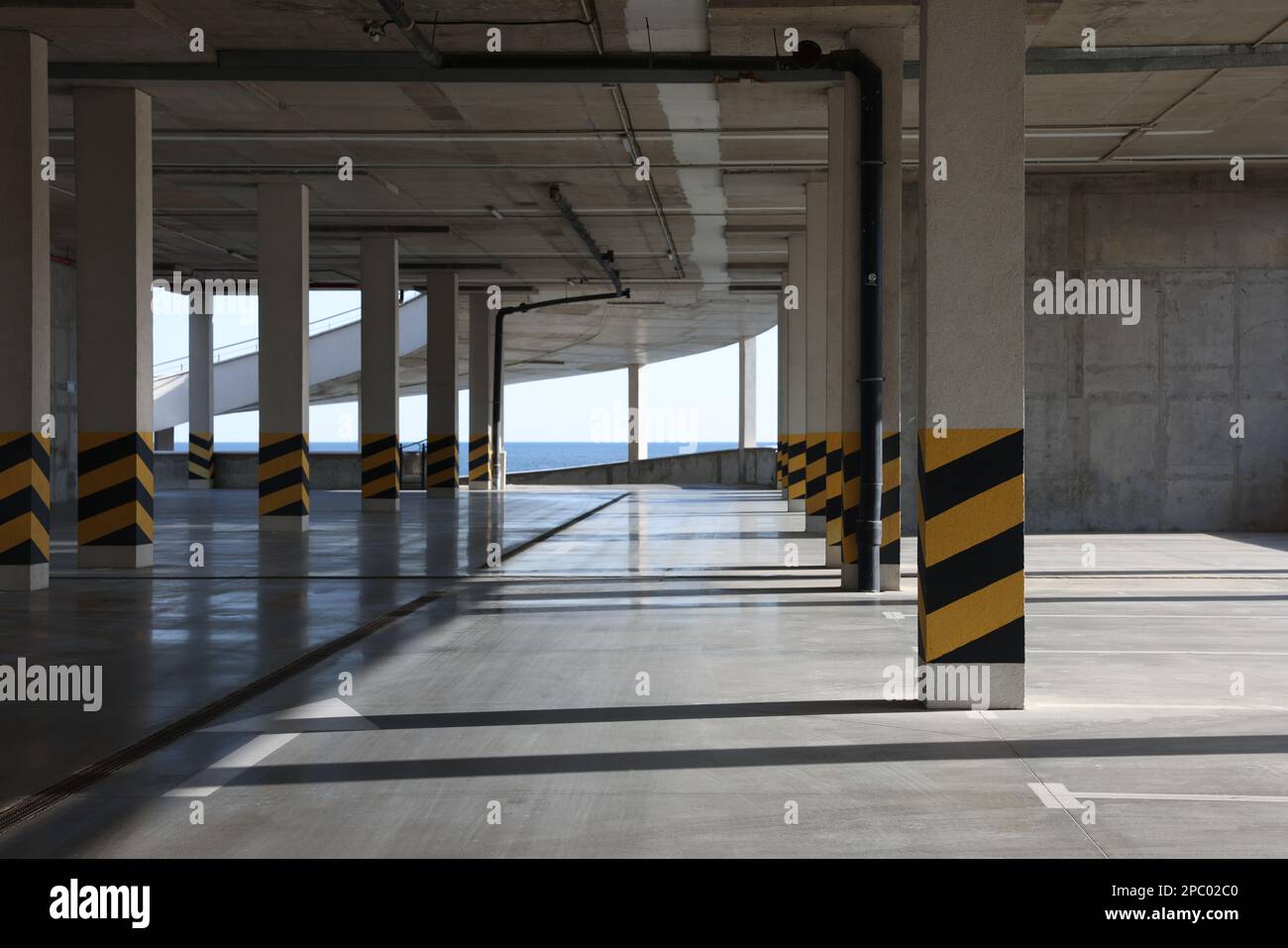 Empty open car parking garage on sunny day Stock Photo - Alamy