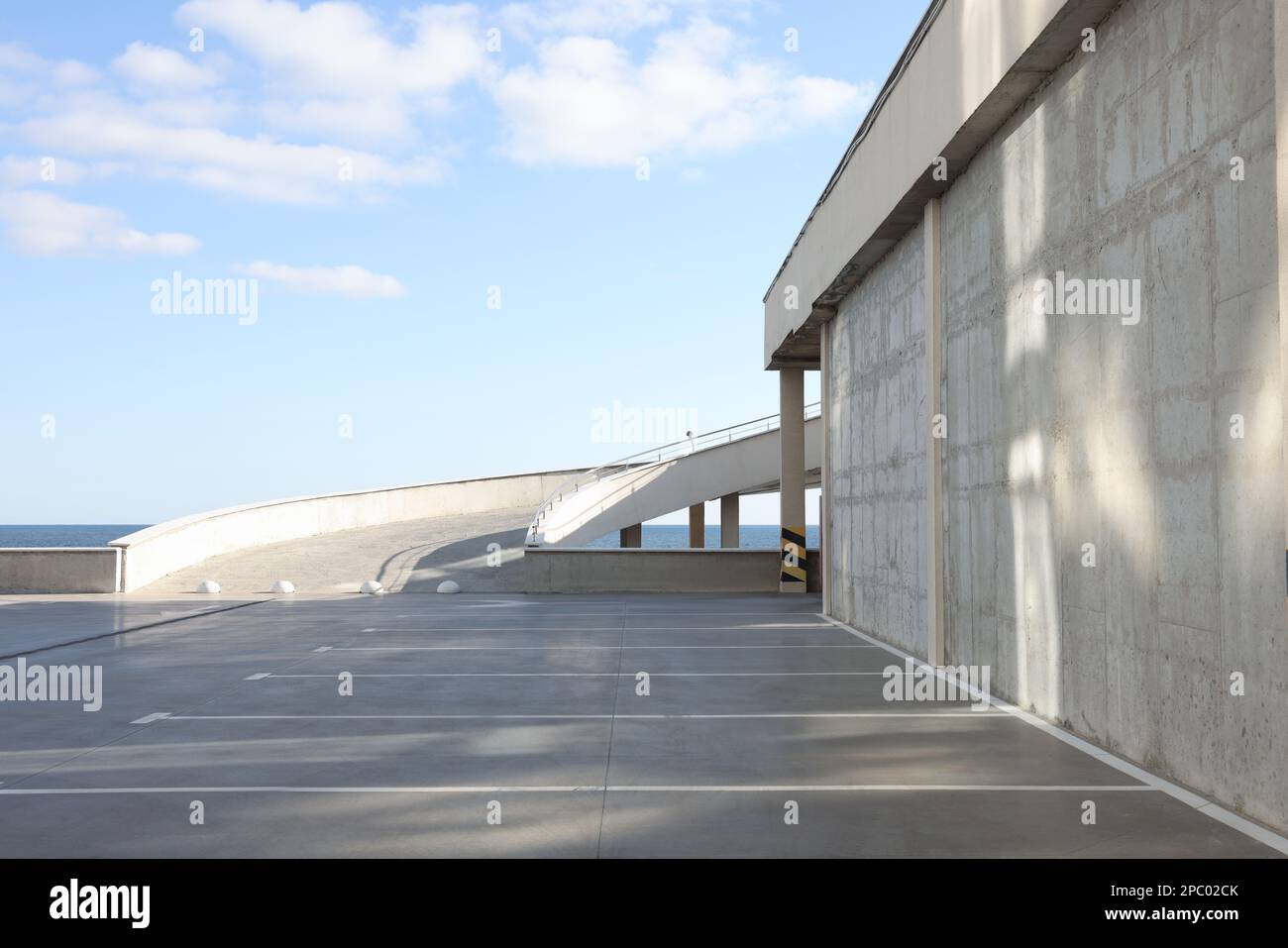 Empty outdoor car parking lot with ramp on sunny day Stock Photo - Alamy