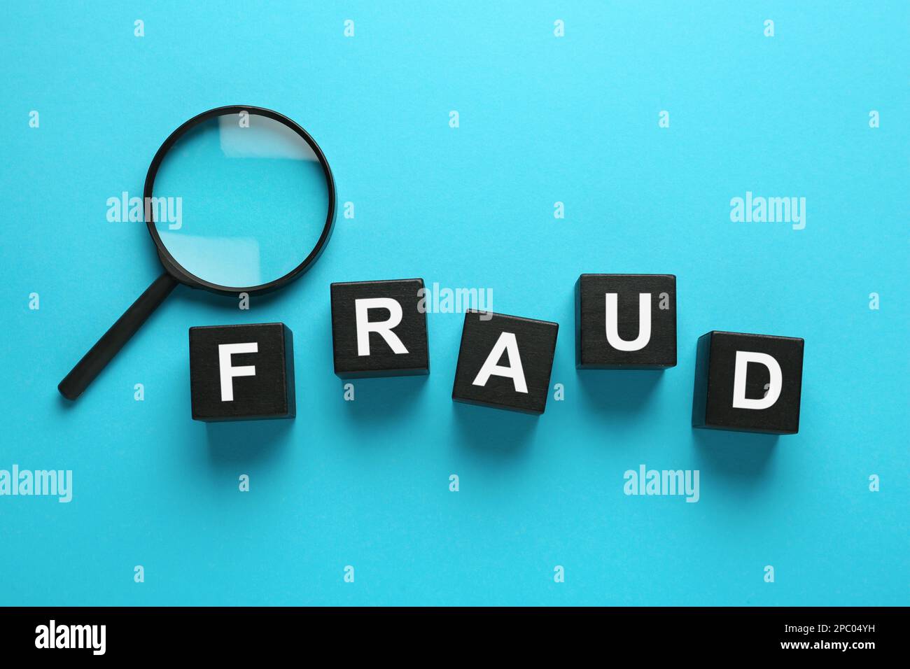 Black cubes with word Fraud and magnifying glass on light blue ...